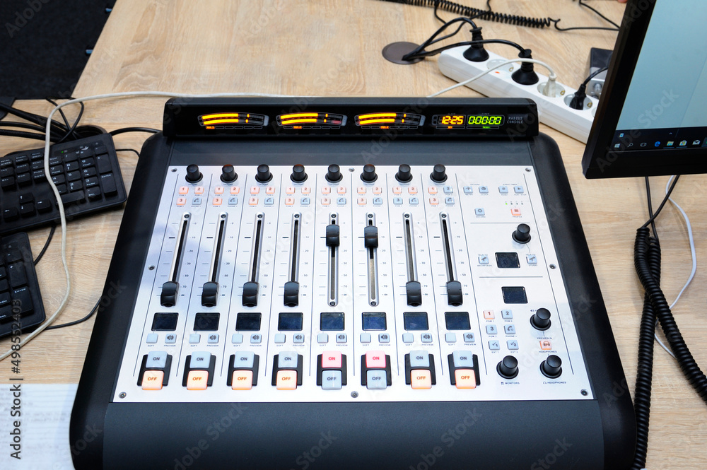 Audio mixer control panel working at a radio studio. Buttons, volume ...