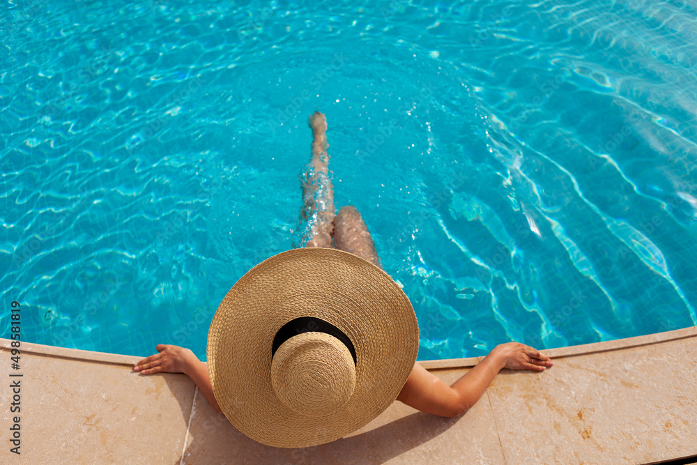 Beautiful woman sunbathing by the pool top view horizontal. Summer ...