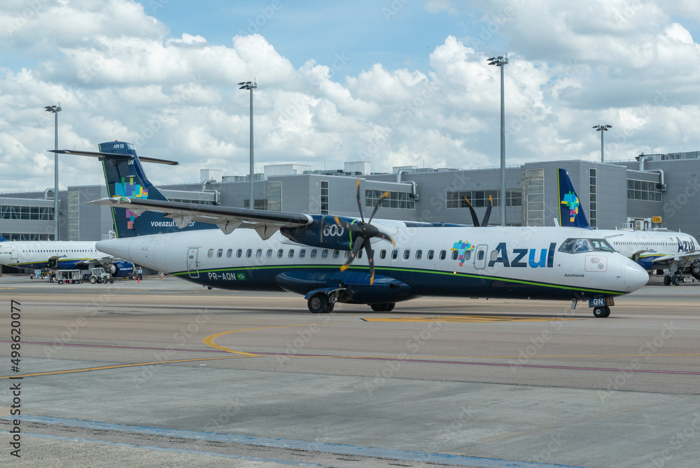 Side view of ATR-72 model turboprop passenger plane parking at the ...