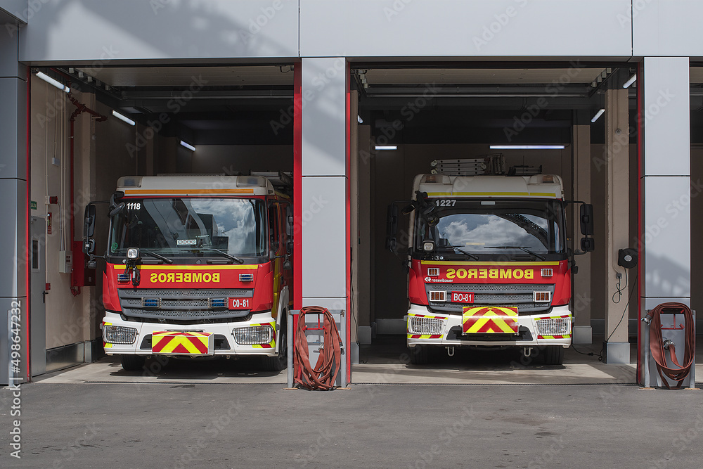 Two Spanish fire trucks, parked in the fire station. There are no ...
