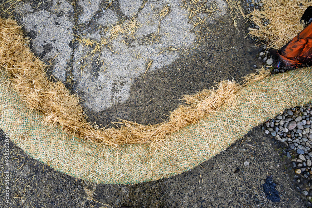 Straw containment barrier on the driveway of a residential construction ...
