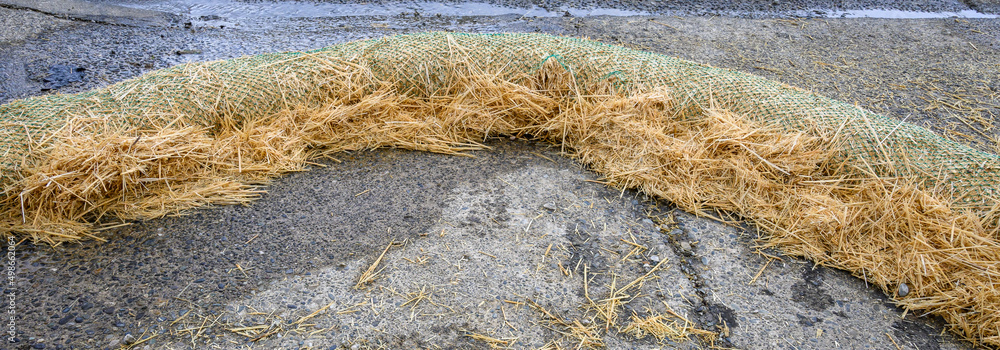 Straw containment barrier on the driveway of a residential construction ...
