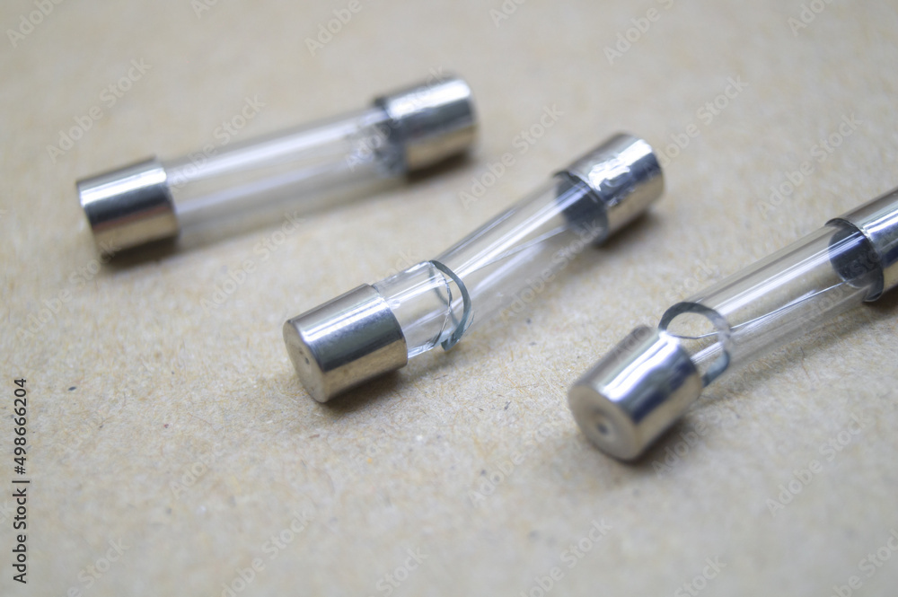Broken electrical fuses with split glass housing. Broken glass tube ...