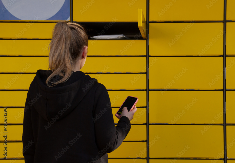 foto-de-beautiful-woman-picking-up-a-package-from-a-smart-electronic