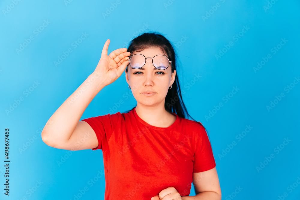 Portrait of a beautiful young brunette girl with glasses on her head ...