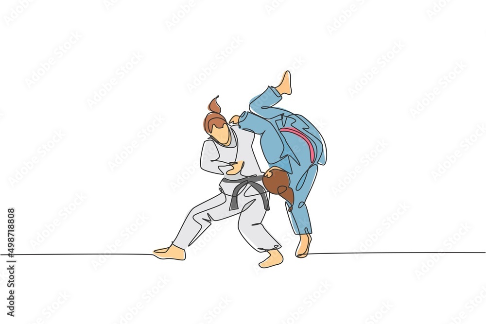 One continuous line drawing two young sporty women training judo ...