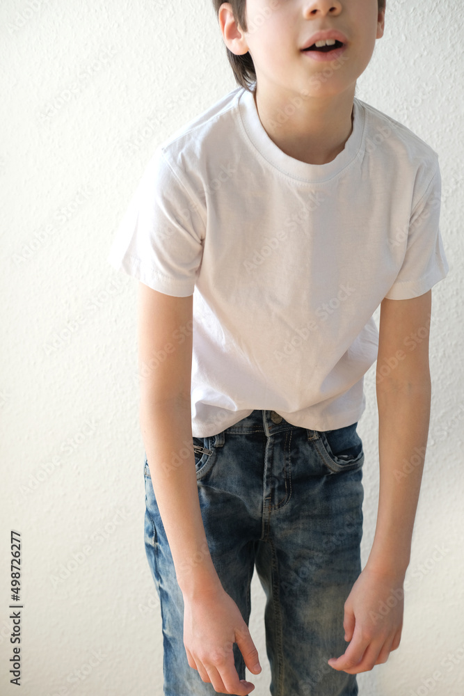 part of boy, child10 years old is standing, hunched over from back pain ...