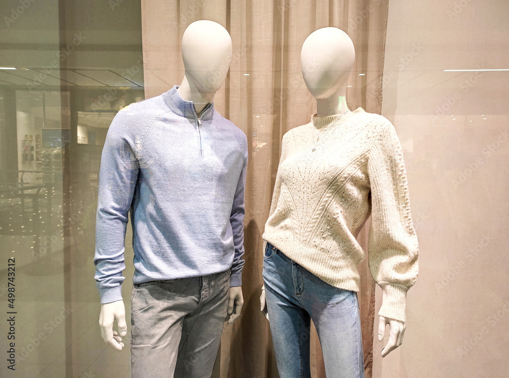 Two mannequins in shop window. Female and male dummies. Family shopping ...