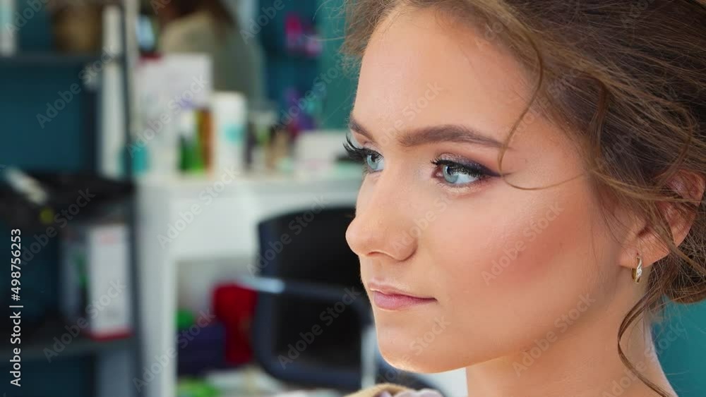 Beautiful face of a brunette girl with makeup in a beauty salon. The ...
