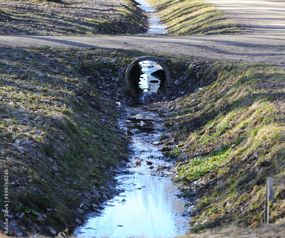Roadside drainage ditch with water in the park фотография Stock | Adobe ...