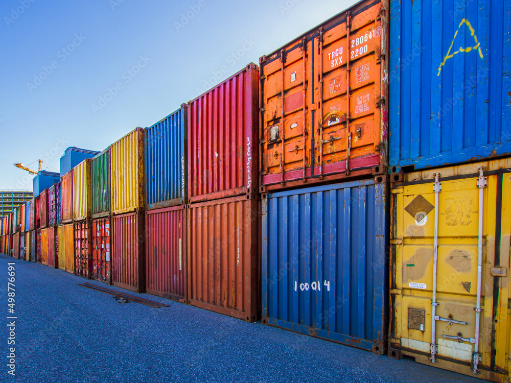 Row of stacked multicovered shipping containers Stock Photo | Adobe Stock