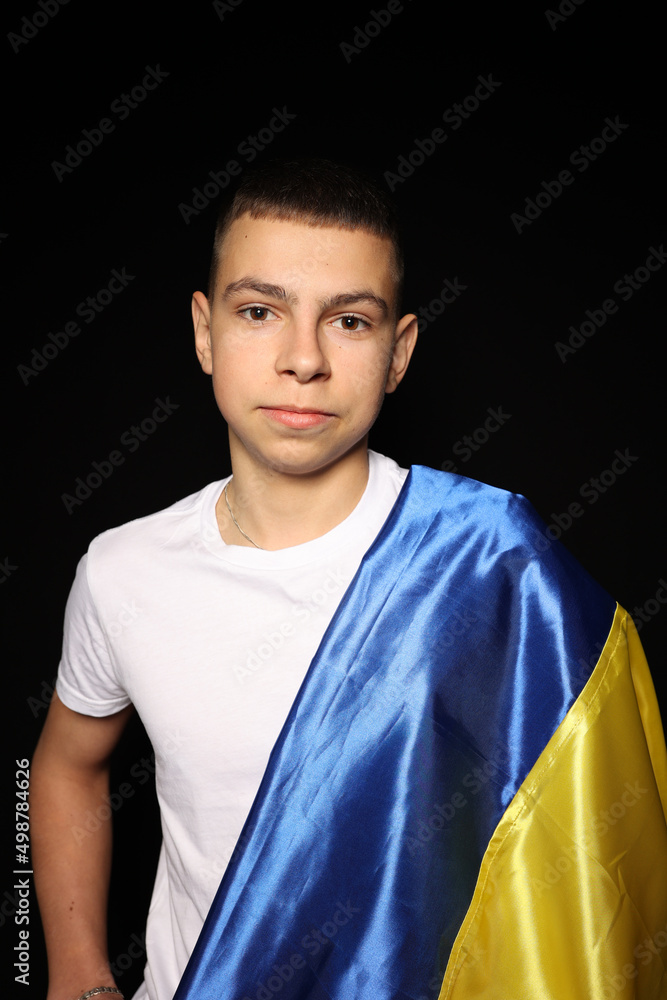 handsome Ukrainian man with Ukraine flag on black background. war in ...