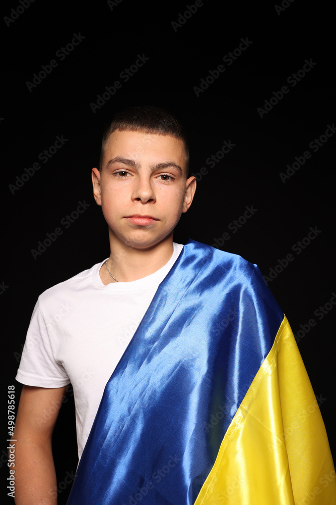 handsome Ukrainian man with Ukraine flag on black background. war in ...