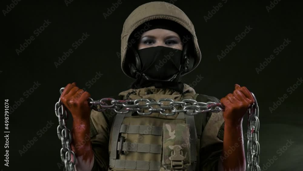 girl soldier in a helmet holds a chain with bloody hands as a symbol of ...