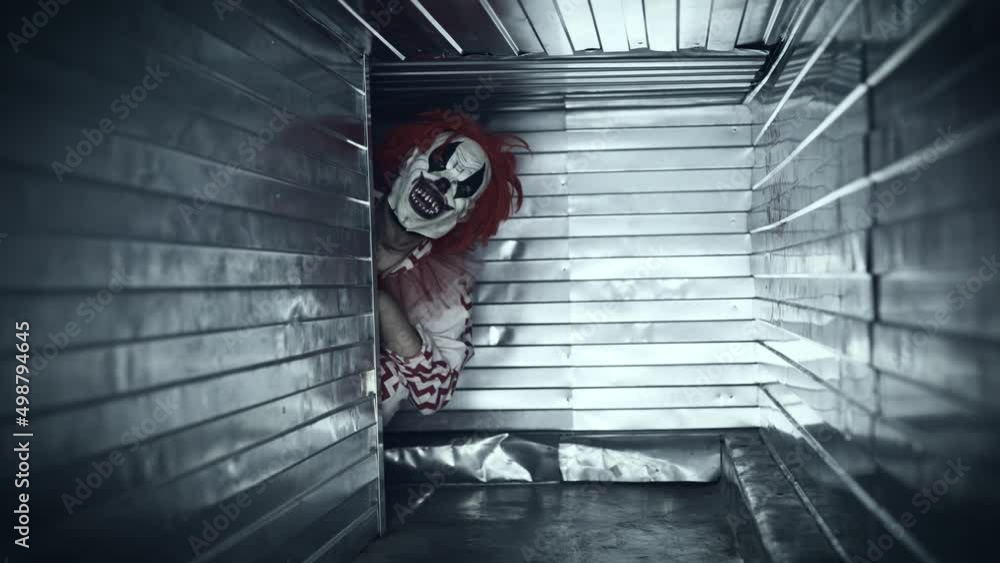 Scary clown attacks in a closed ventilation duct. Scary psychopath in a ...