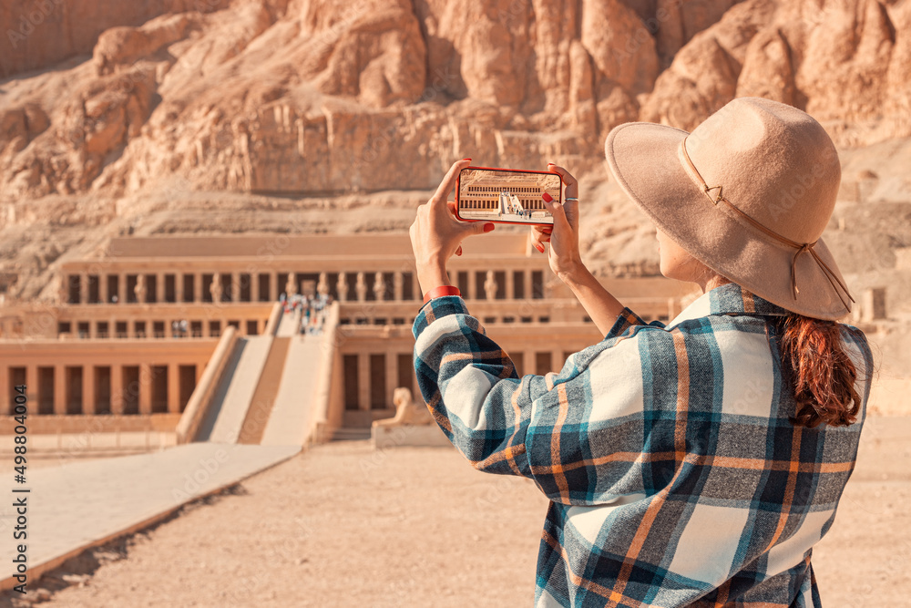 Travel blogger girl takes pictures on a smartphone at the famous ...