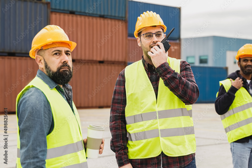Engineer industrial people working at shipping containers port terminal ...