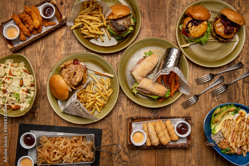 Set of fast food dishes with assorted hamburgers, sandwiches, sweet ...