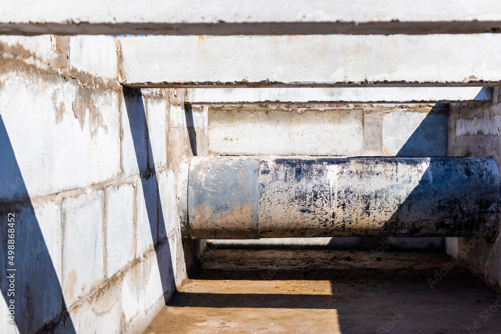 Laying of underground pipes in concrete chamber. Installation of water ...