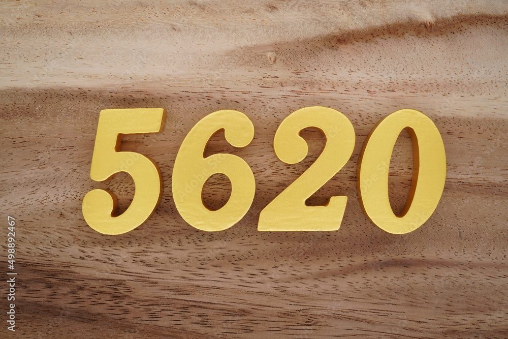 Golden Arabic numerals on a real brown and white wooden floor number ...