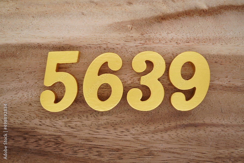 Golden Arabic numerals on a real brown and white wooden floor number ...