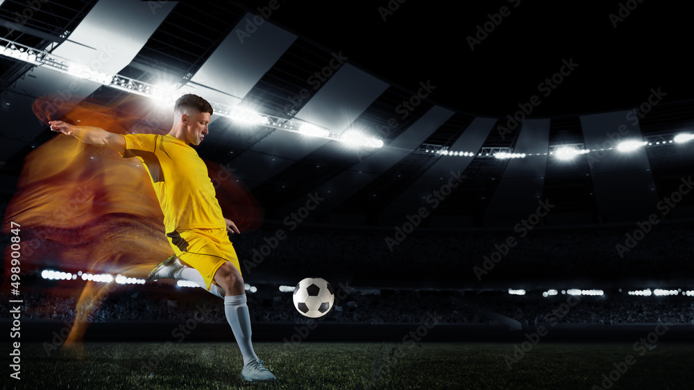 Professional football or soccer player in action on stadium with ...