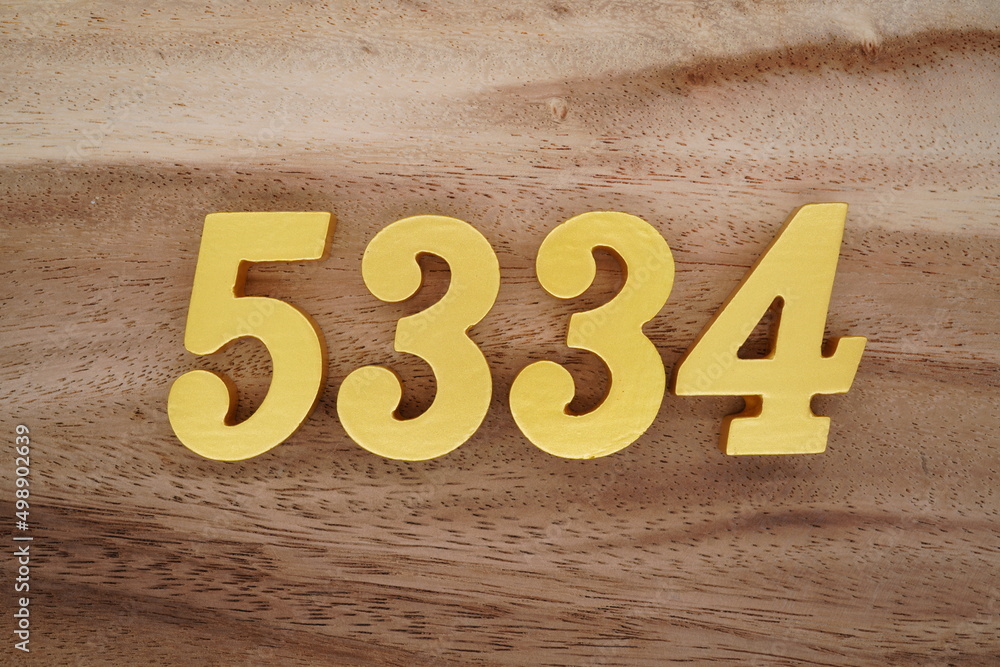 Golden Arabic numerals on a real brown and white wooden floor number ...