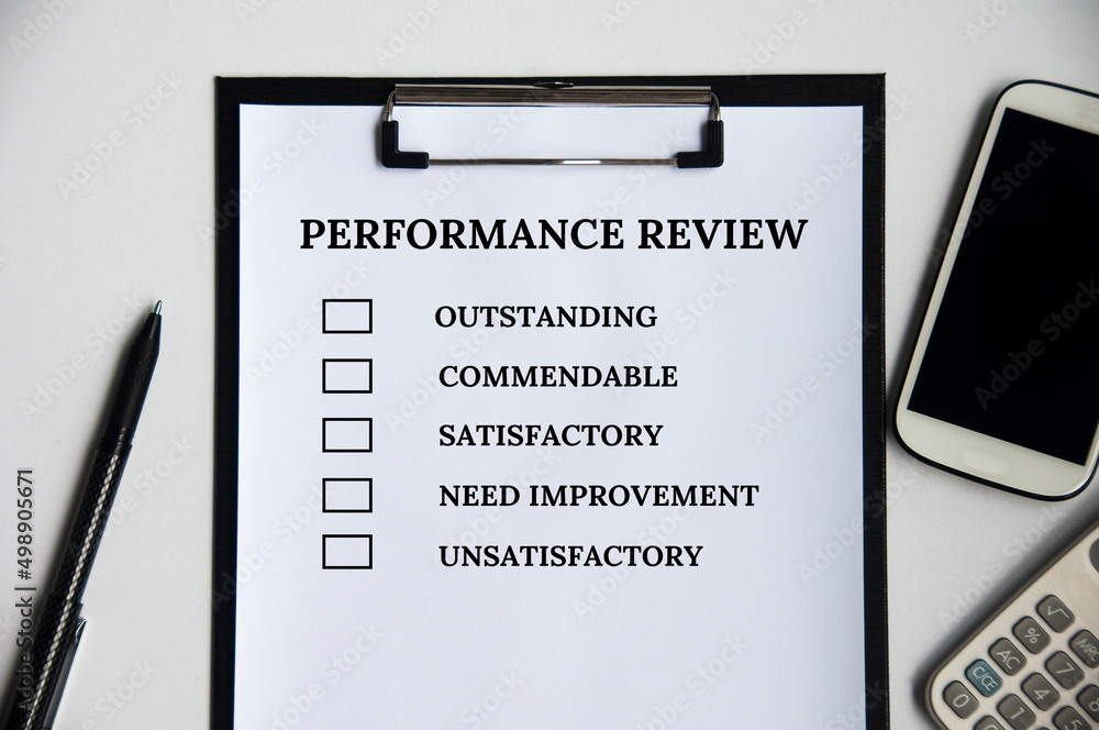 Top view of performance Appraisal checklist on clip board with white ...