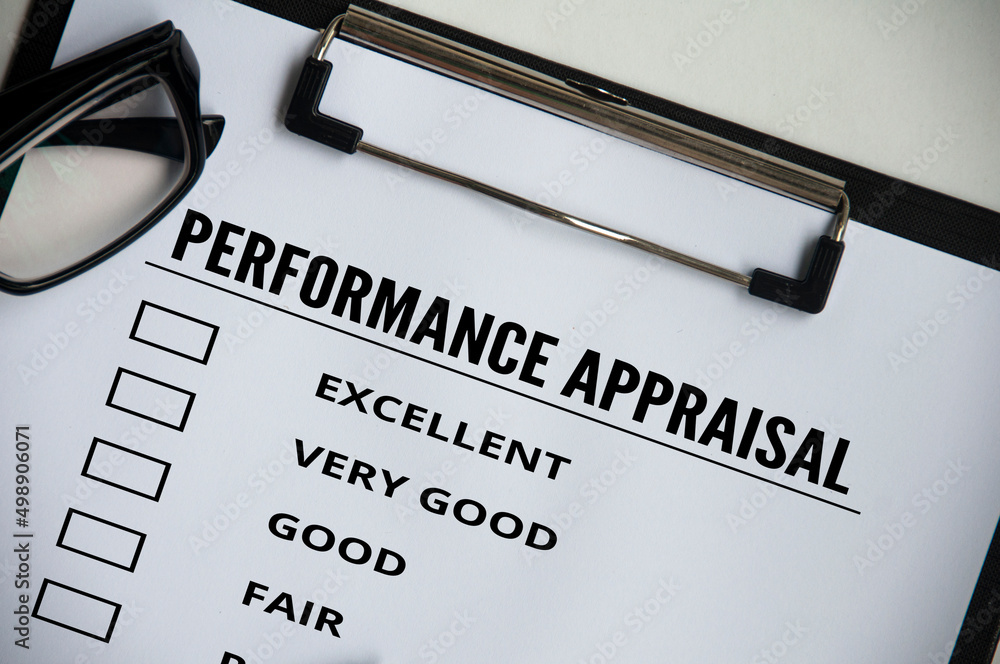 Top view of performance Appraisal checklist on clip board with glasses ...