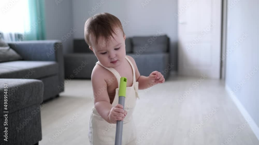 Cute children brother and sister toddler sweep the floor with mops ...