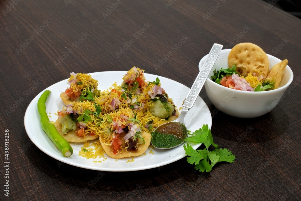 A beautiful picture of sev puri papri chat served in a dish and a bowl ...
