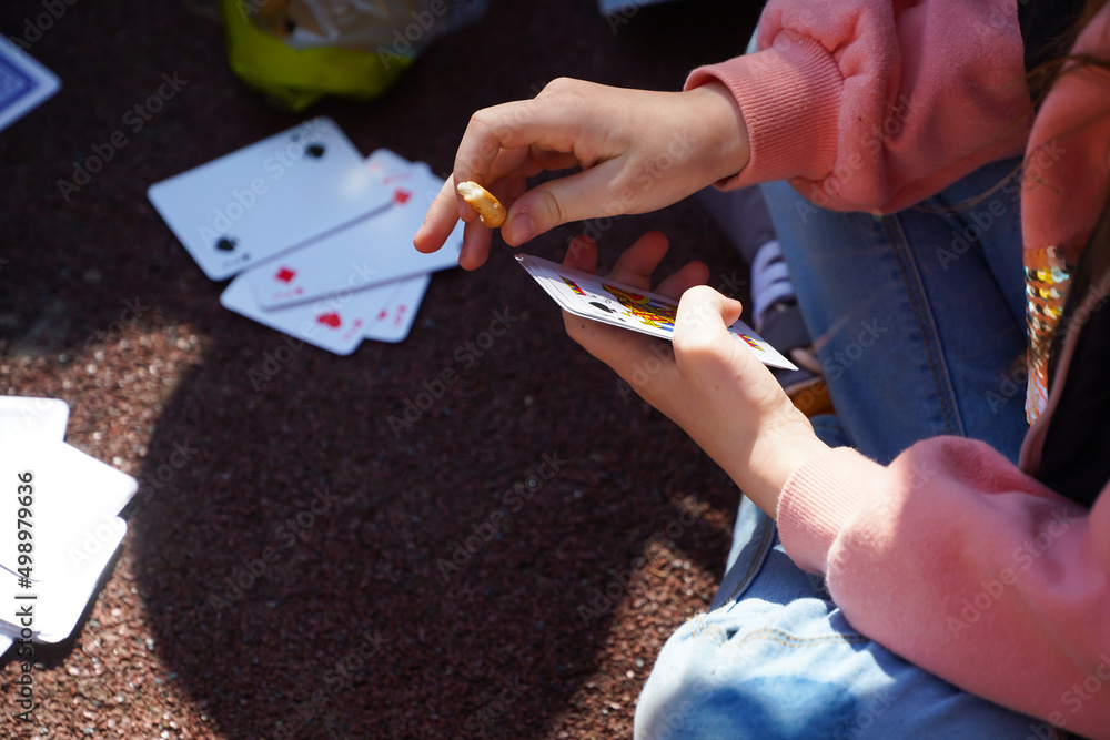 card game. children playing a card game in the park. detail. Stock ...
