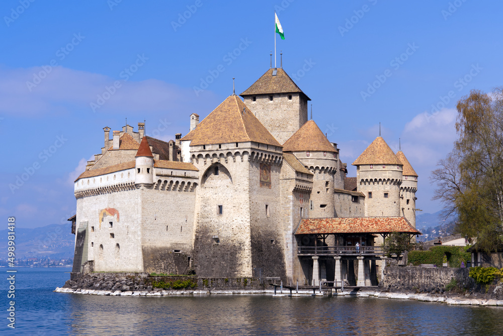 Famous medieval Chillon Castle at border of Lake Geneva on a blue ...
