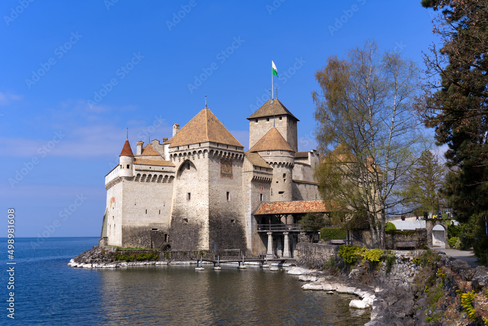 Famous medieval Chillon Castle at border of Lake Geneva on a blue ...