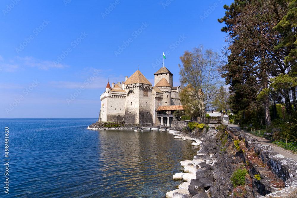 Famous medieval Chillon Castle at border of Lake Geneva on a blue ...