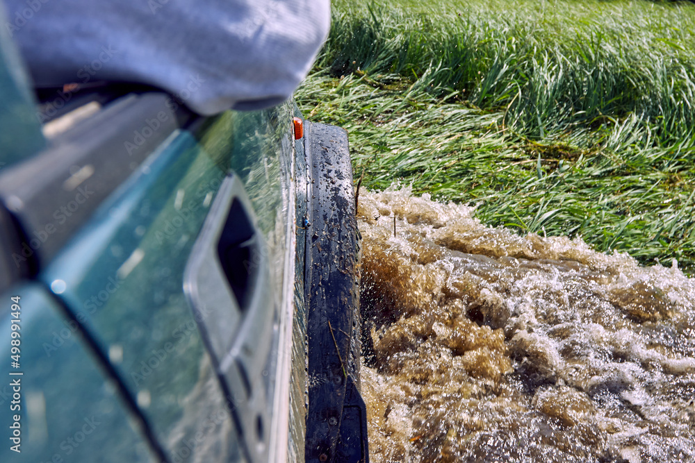 4x4 SUV deep ford during extreme competitions. Off-road car racing. The ...