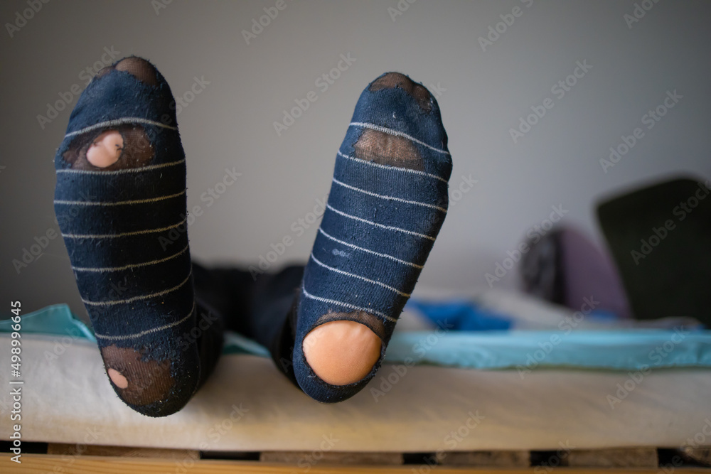 Poor russian man with spongy and worn out socks. The concept of poverty ...