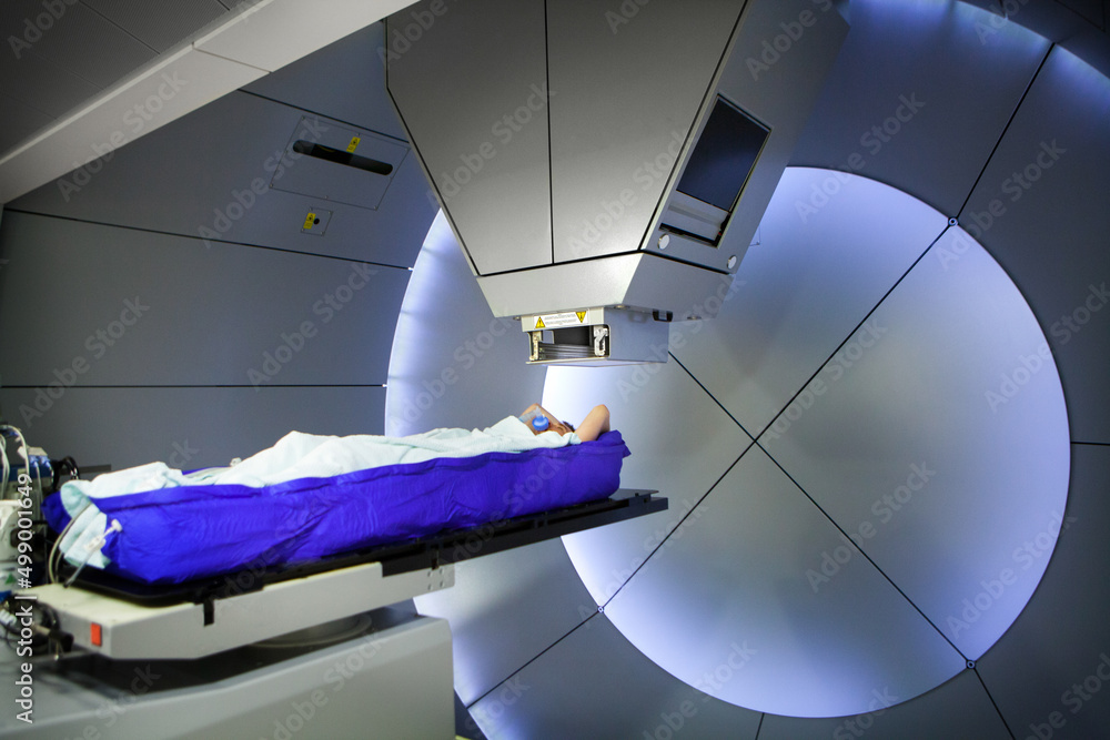 Proton therapy irradiates cancer cells with a beam of protons inside ...