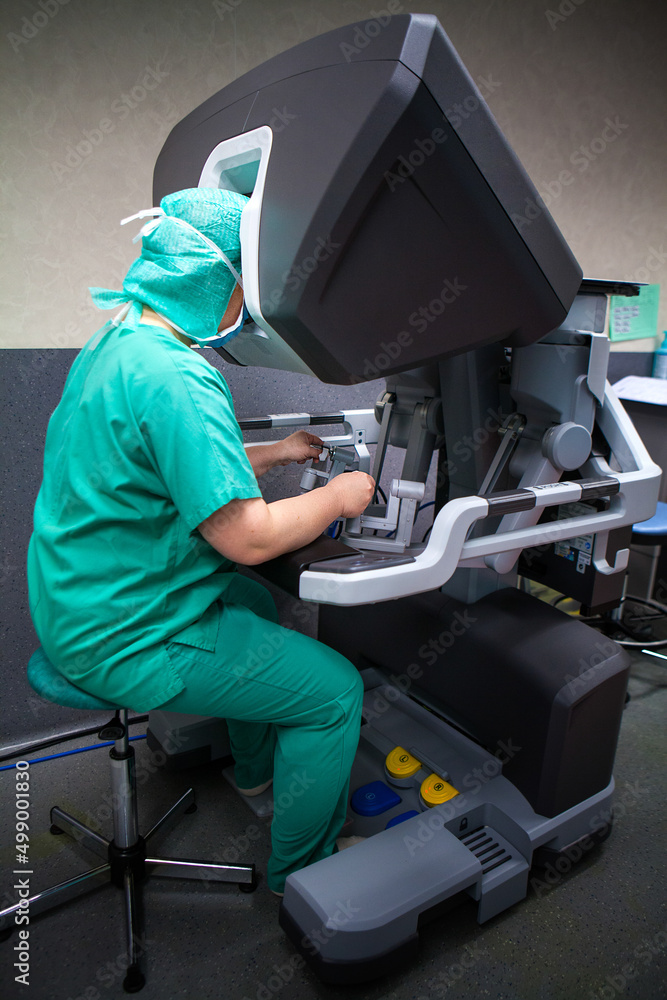 Surgeon piloting a surgical robot from the console. Stock Photo | Adobe ...
