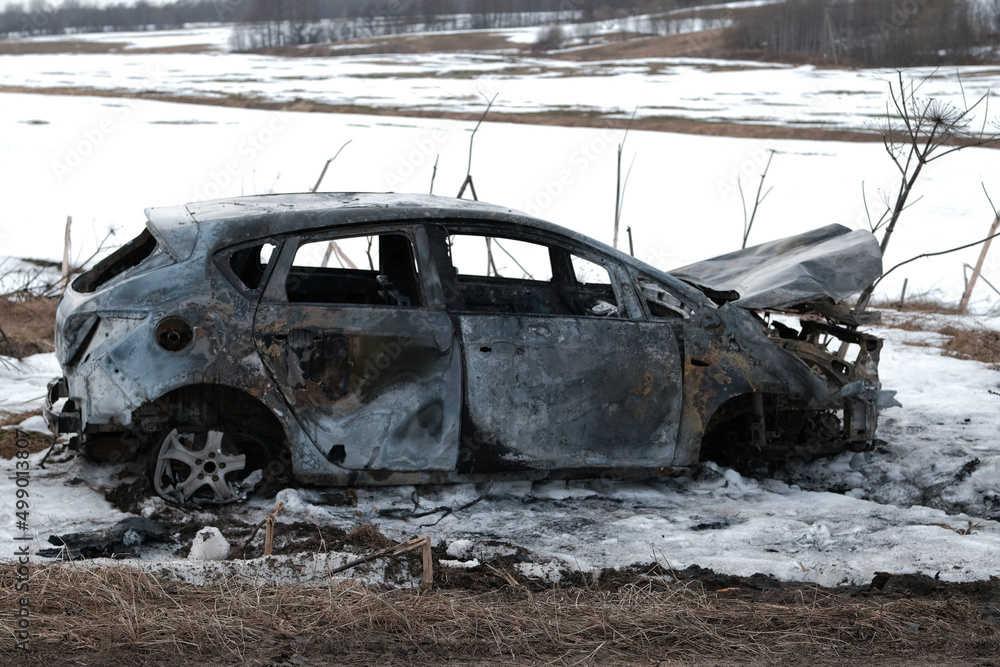 Burnt car with small flames inside of the engine. Burnt new car ...