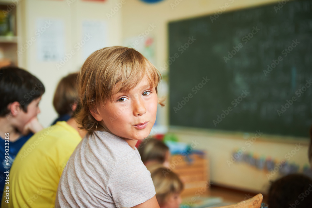 Cute little boy working in classroom, education, back to school concept ...