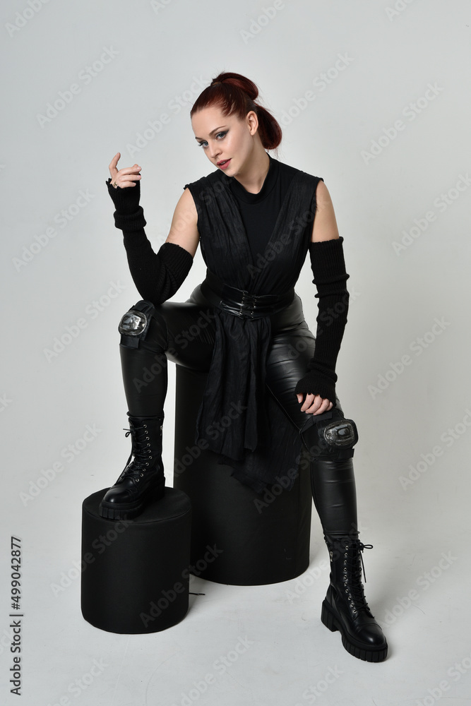 Full length portrait of pretty redhead female model wearing black ...