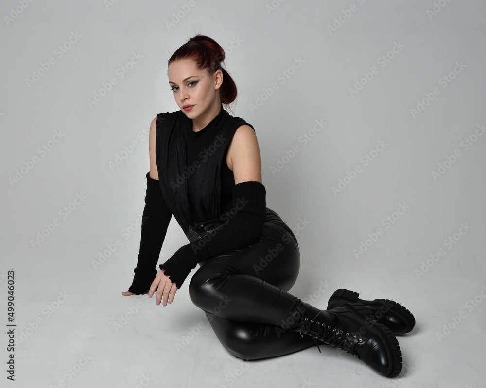 Full length portrait of pretty redhead female model wearing black ...