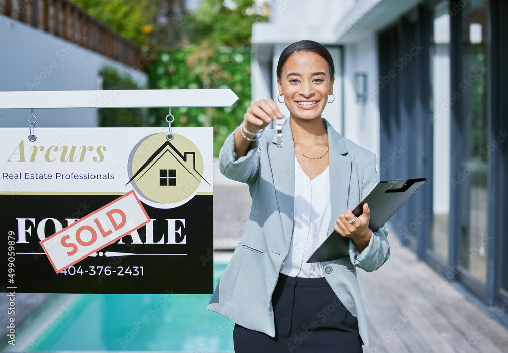 Congratulations, its all yours. Shot of a young female real estate ...