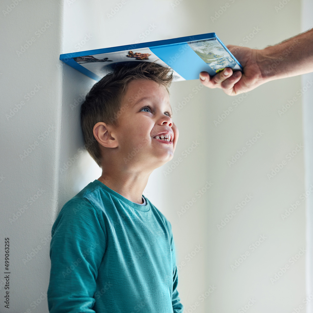 Hes getting taller and taller by the day. Cropped shot of a little boy ...