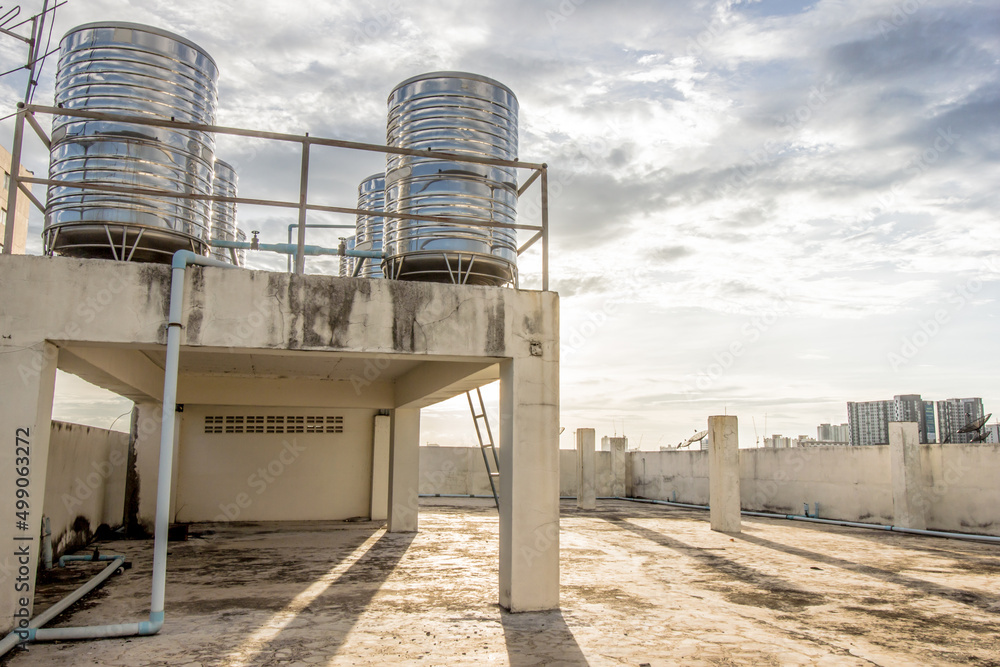 The water tank is located on the building. Stock Photo | Adobe Stock