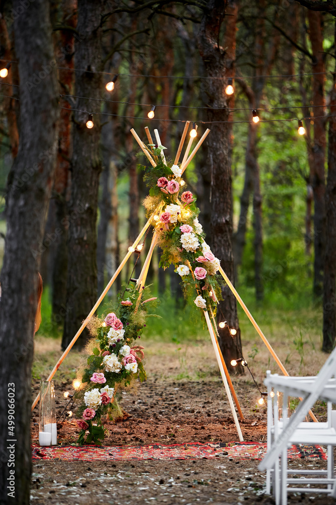 Bohemian tipi arch made of wooden rods decorated with pink roses ...