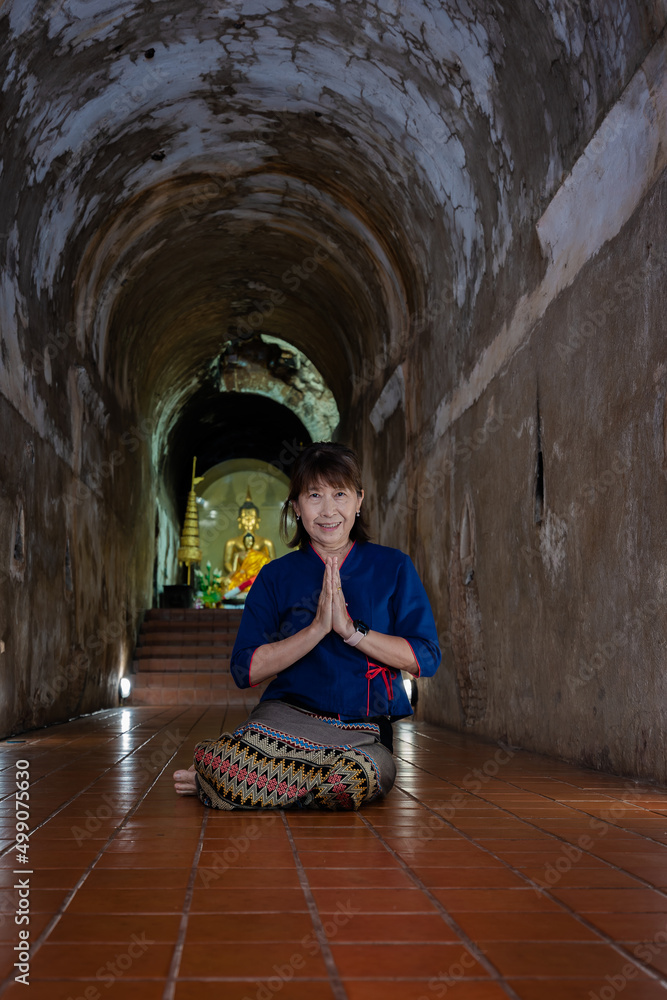 Asian Buddhist women pray at the ancient tunnel Temple or Wat U-Mong ...