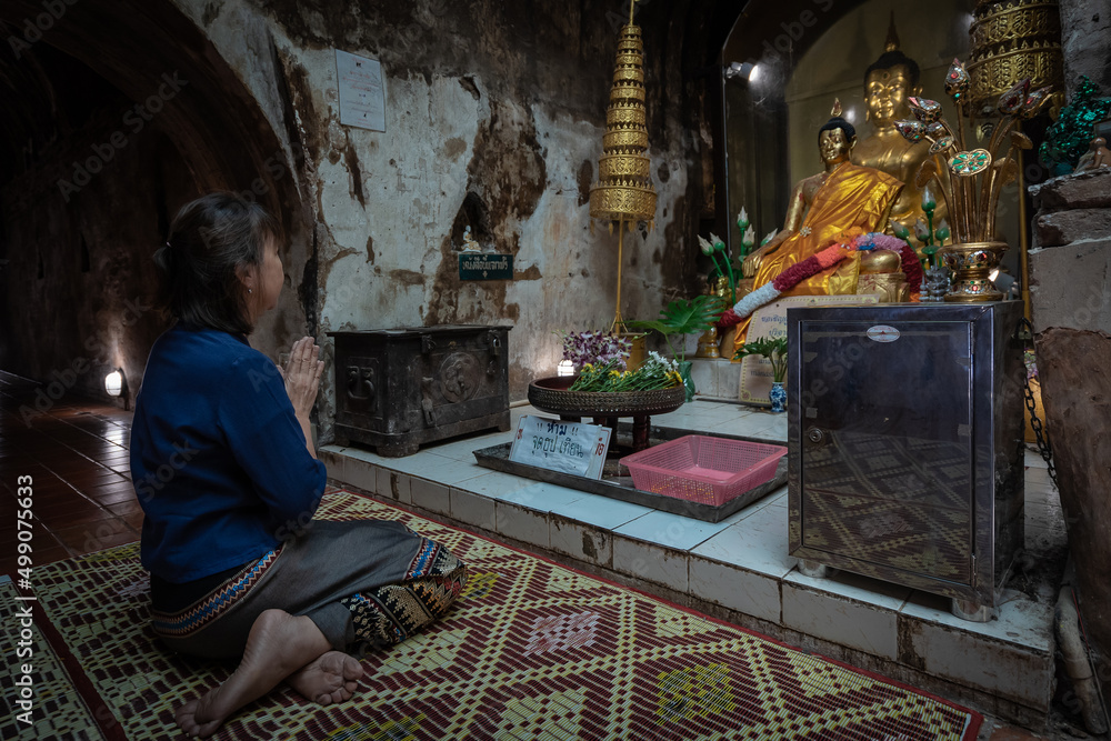 Asian Buddhist women pray at the ancient tunnel Temple or Wat U-Mong ...