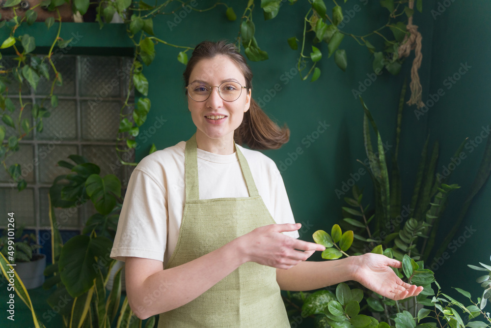 Professional female gardener talks about caring for plants. Online ...